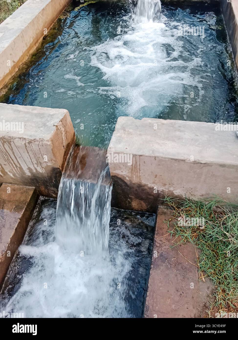 traditional water source from tube well in a rural area. Water flows ...
