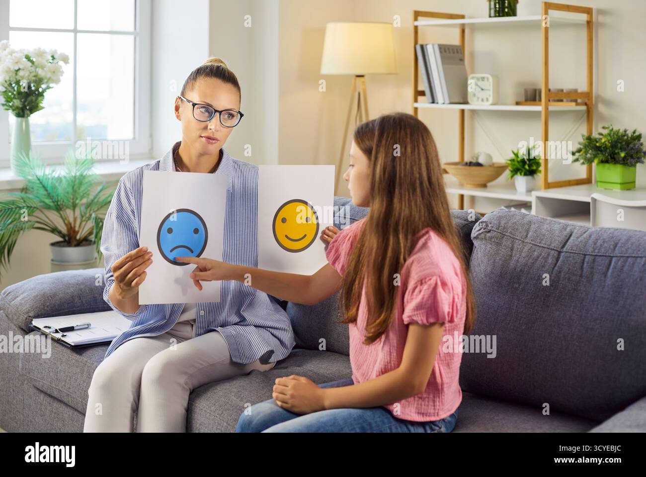 Child counseling session with psychologist using emotion cards for ...