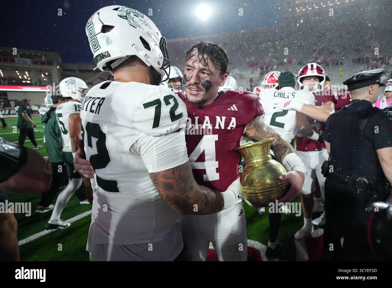 Indiana linebacker Aiden Fisher (4) meets with Michigan State offensive ...