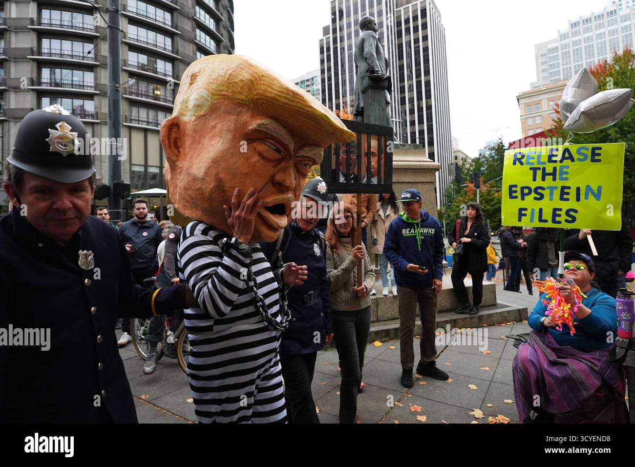 A protester dressed as President Donald Trump in chains and a prison ...