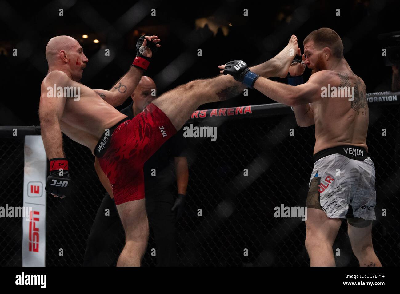 Kyle Nelson, left, of Canada, kicks Matt Frevola, right, during a ...