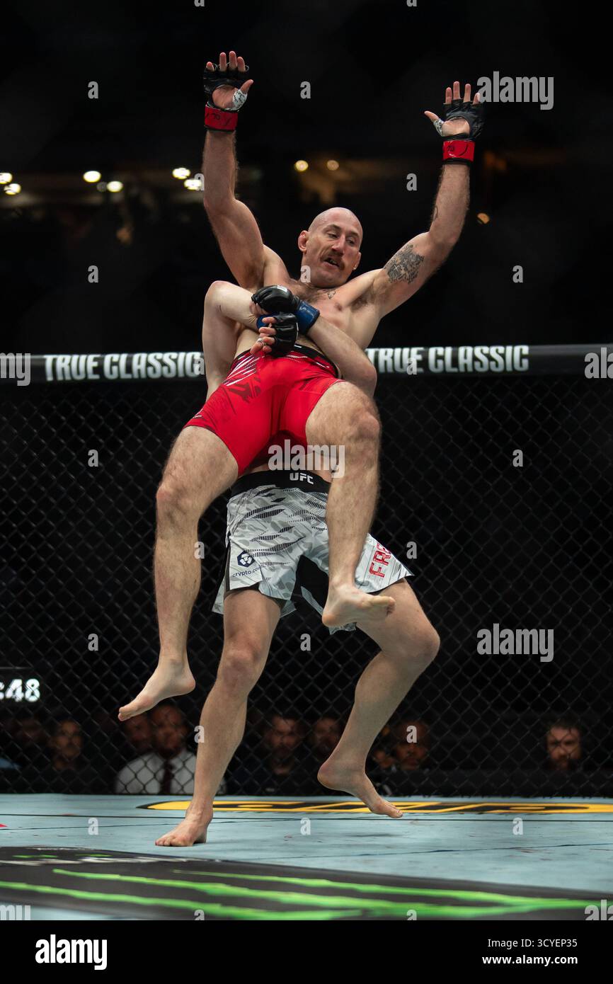 Kyle Nelson, front, of Canada, is picked up by Matt Frevola, back ...