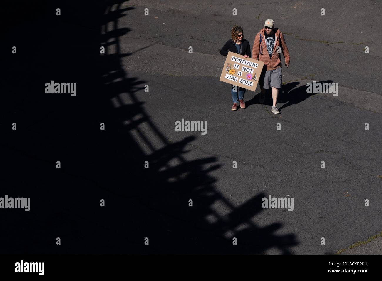 People walk by shadows from demonstrators on the Morrison Bridge during ...
