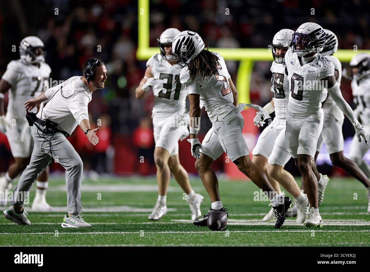 Oregon head coach Dan Lanning, left, congratulates defensive back ...