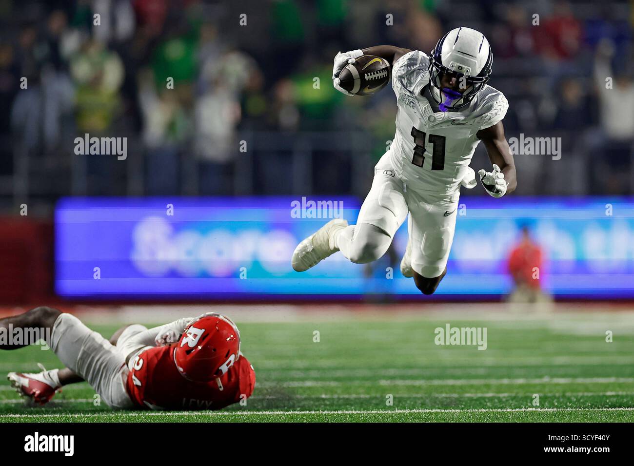 Oregon wide receiver Jeremiah McClellan (11) is tackled by Rutgers ...