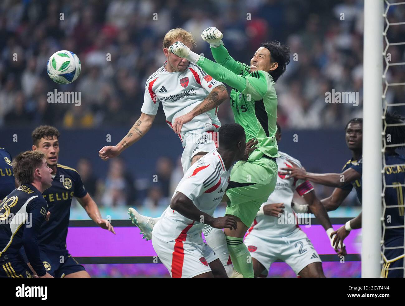 Vancouver Whitecaps' goalkeeper Yohei Takaoka, back right, punches the ...