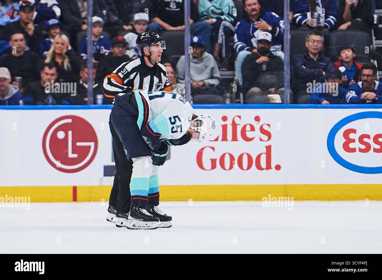 Seattle Kraken's Ryan Lindgren (55) is helped off the ice after ...