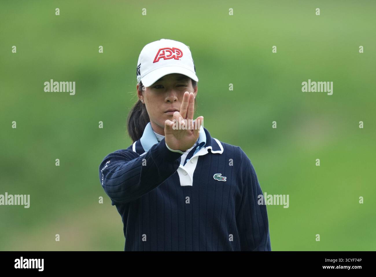 Celine Boutier of France lines up a putt on the first green during the ...