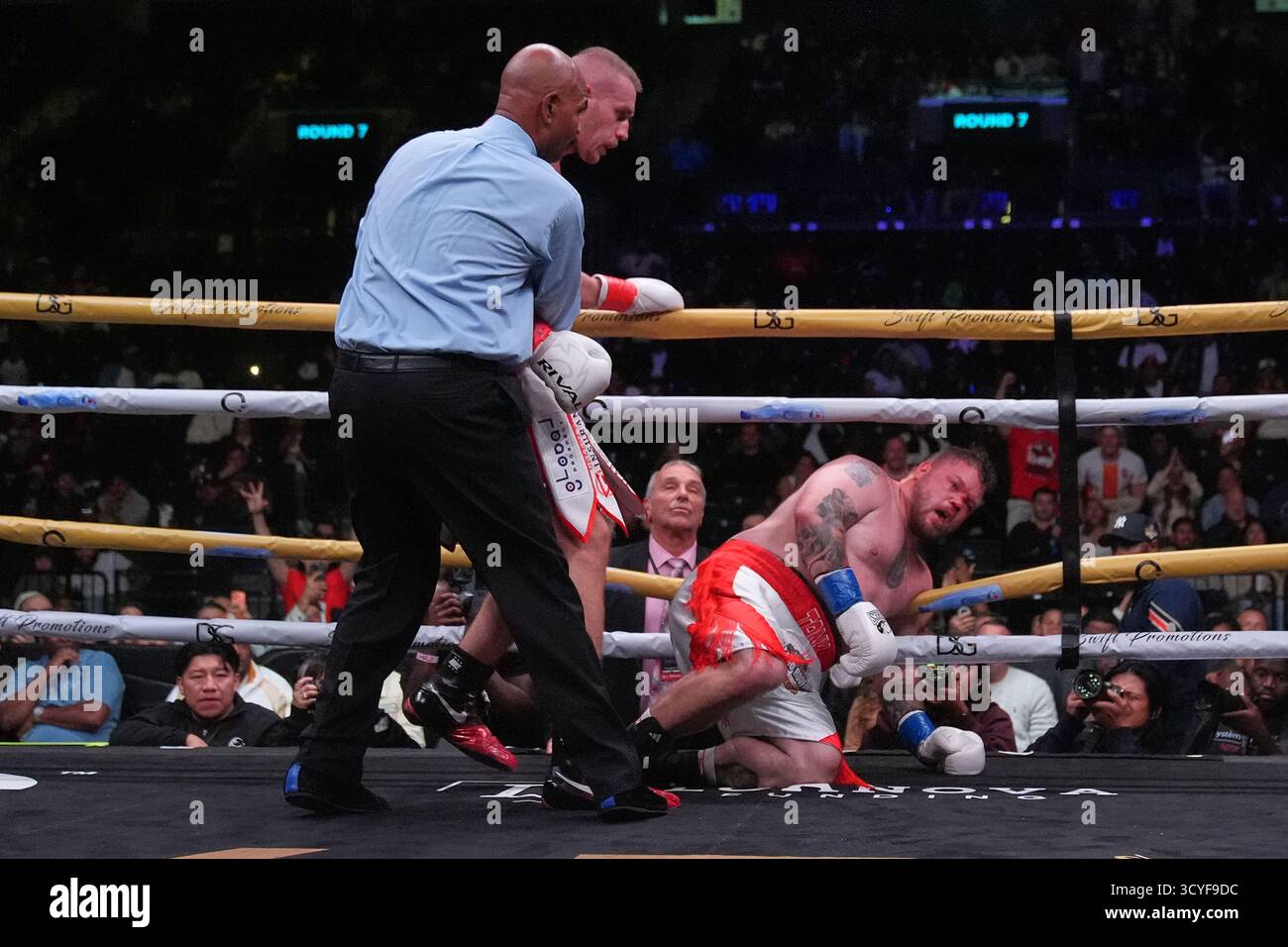 The referee restrains Poland's Damian Knyba after Joey Dawejko, right ...