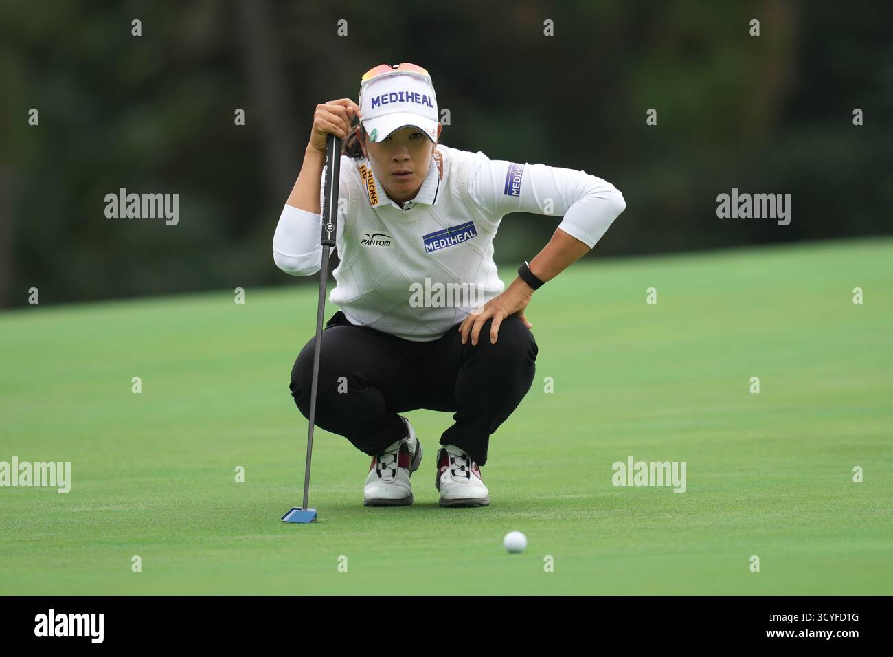 A Lim Kim of South Korea lines up a putt on the first green during the ...