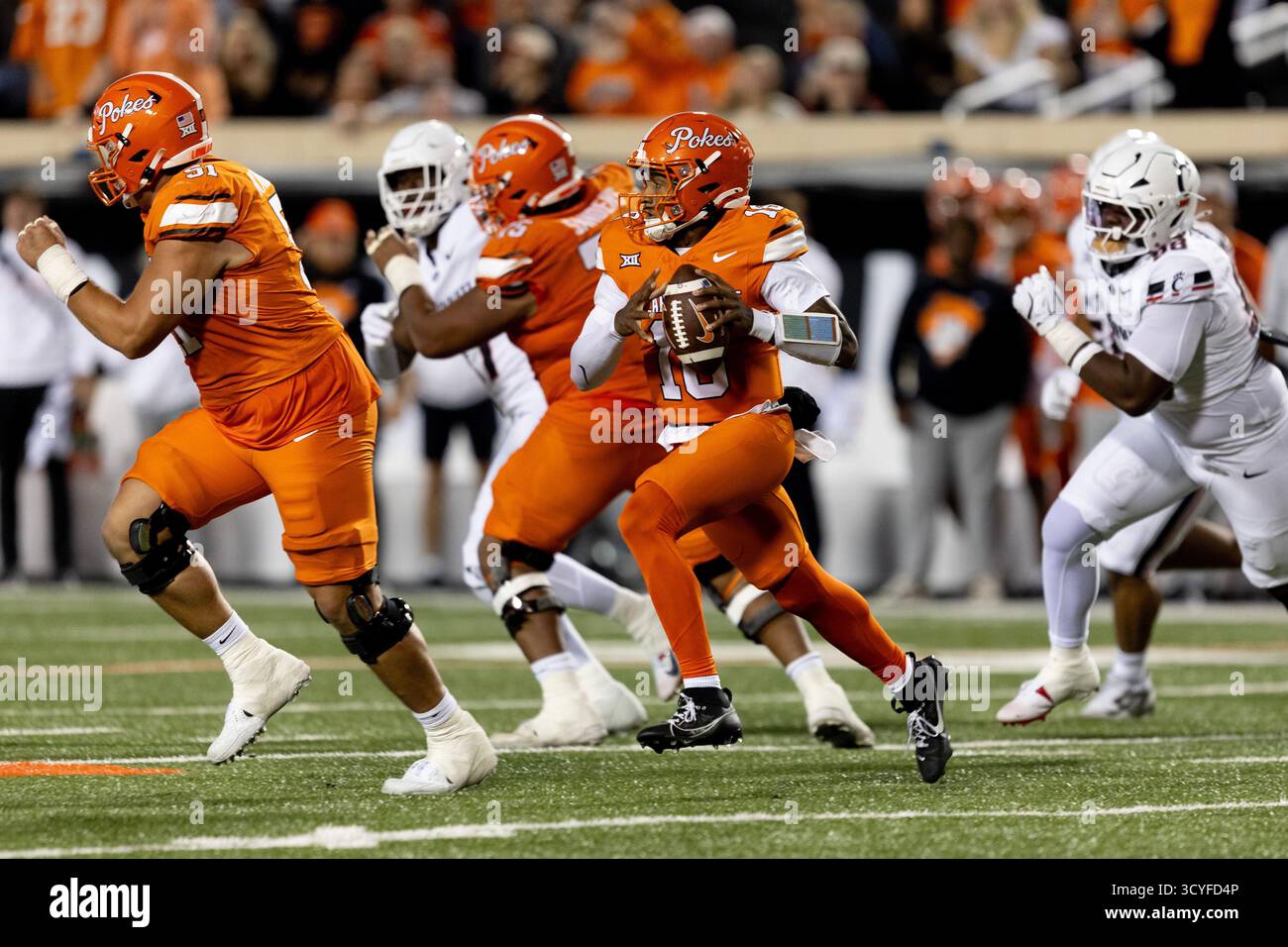 Oklahoma State quarterback Sam Jackson V (18) runs out of the pocket in ...