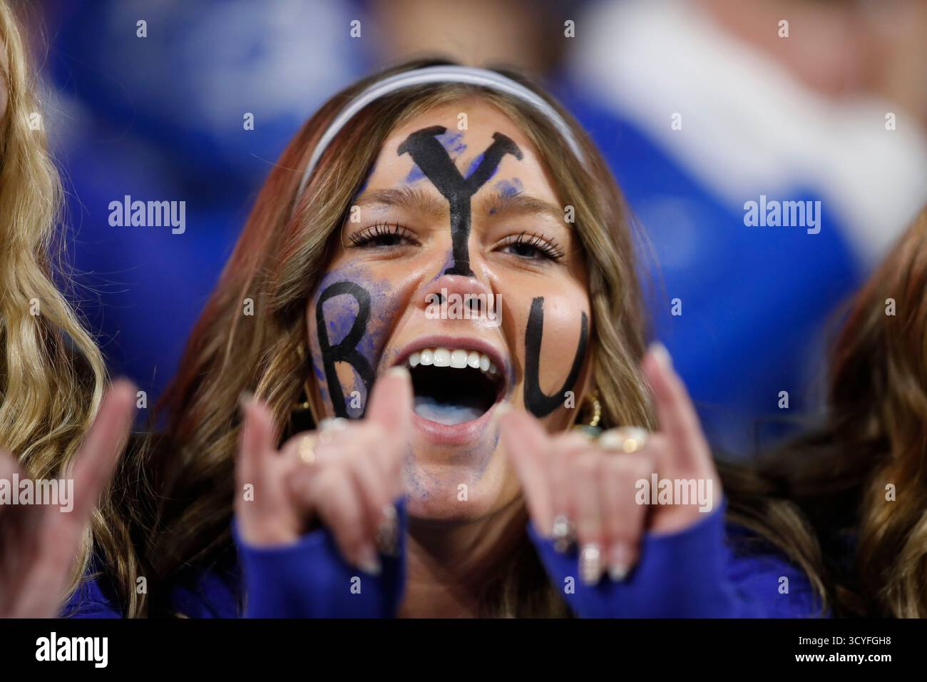 A BYU fan cheers after a touchdown during the second half of an NCAA ...
