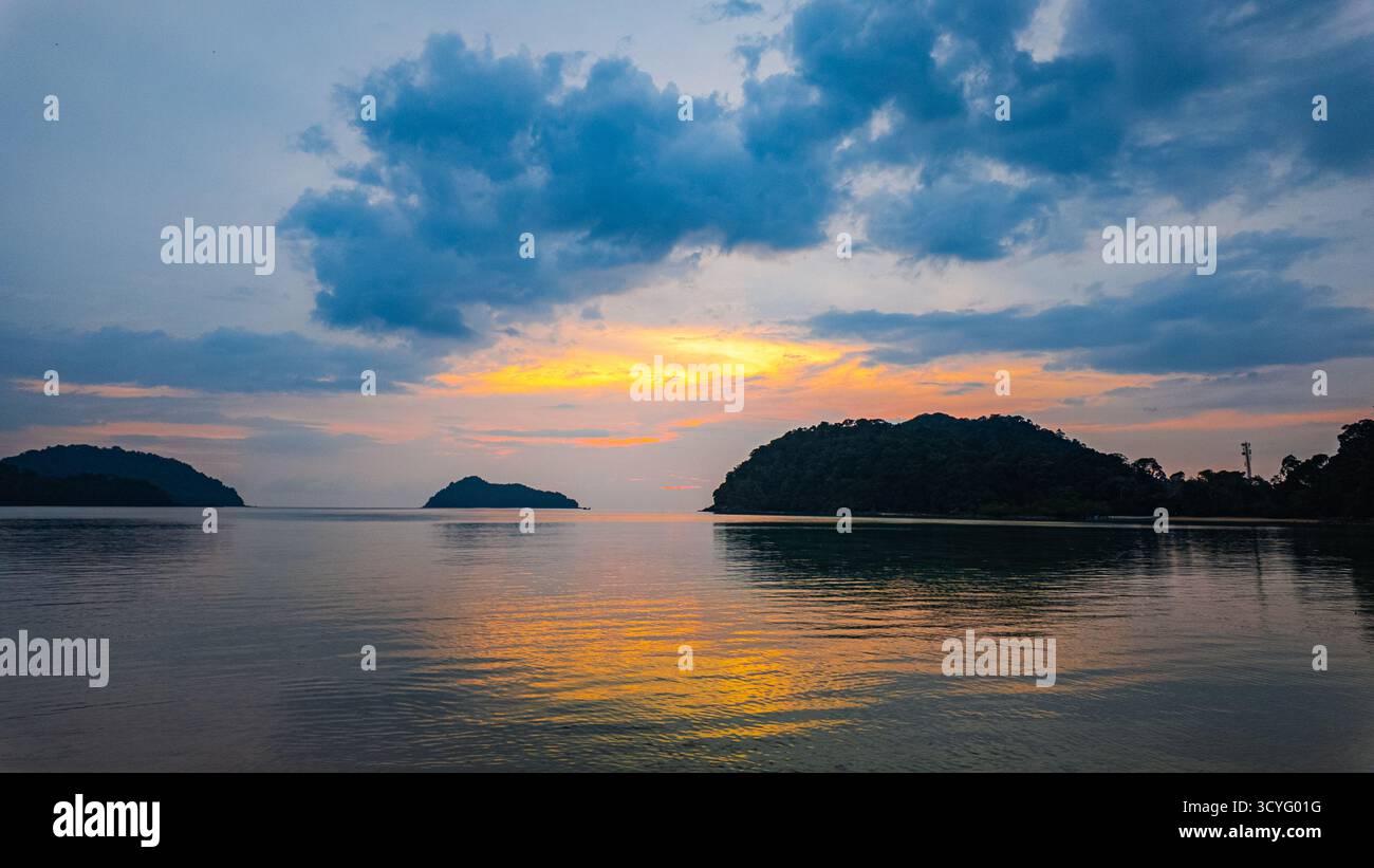 Aerial view of a stunning sunset above the Surin Islands. With golden ...