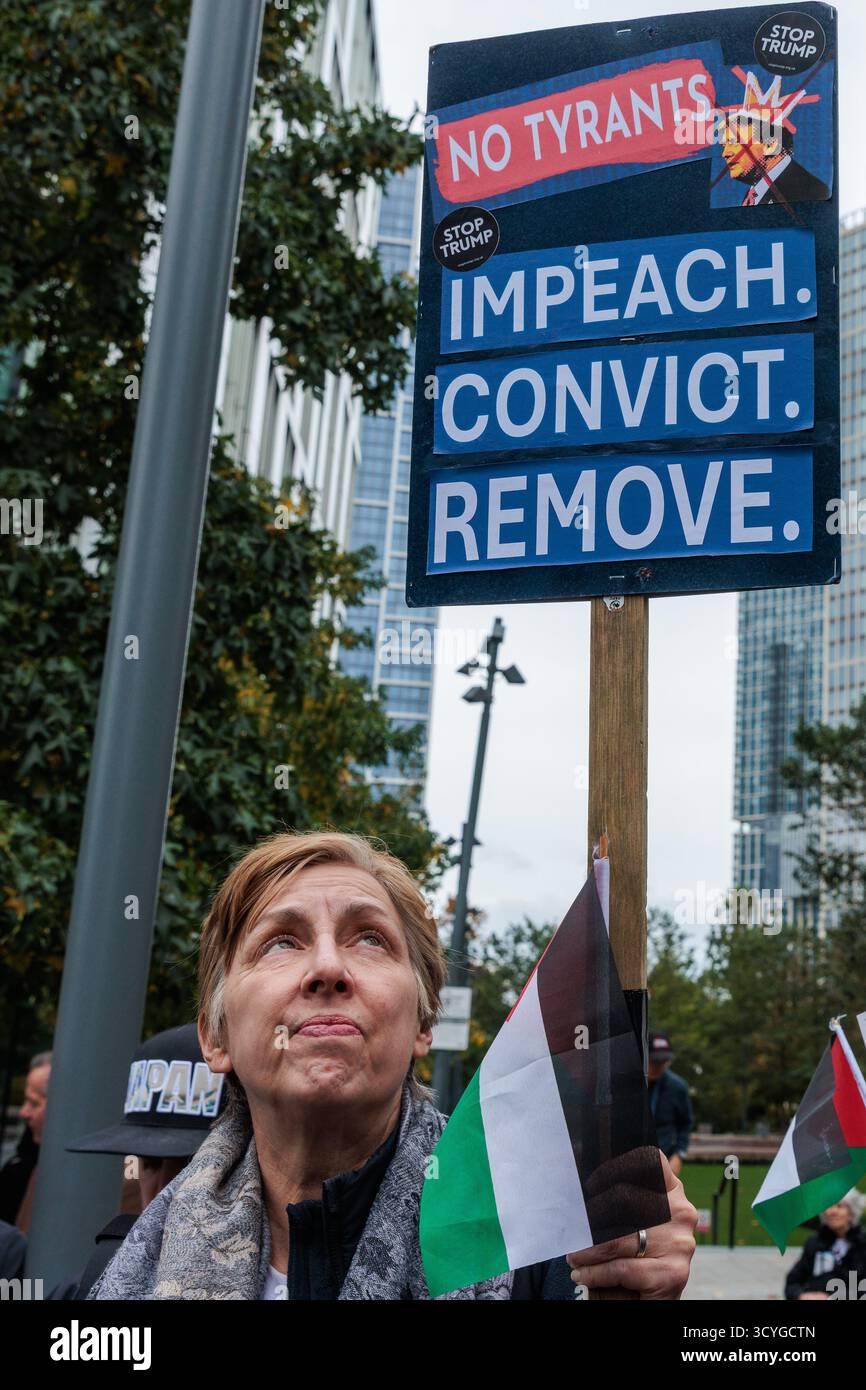 London, UK. 18th October, 2025. A protester holds a sign at a 'No ...