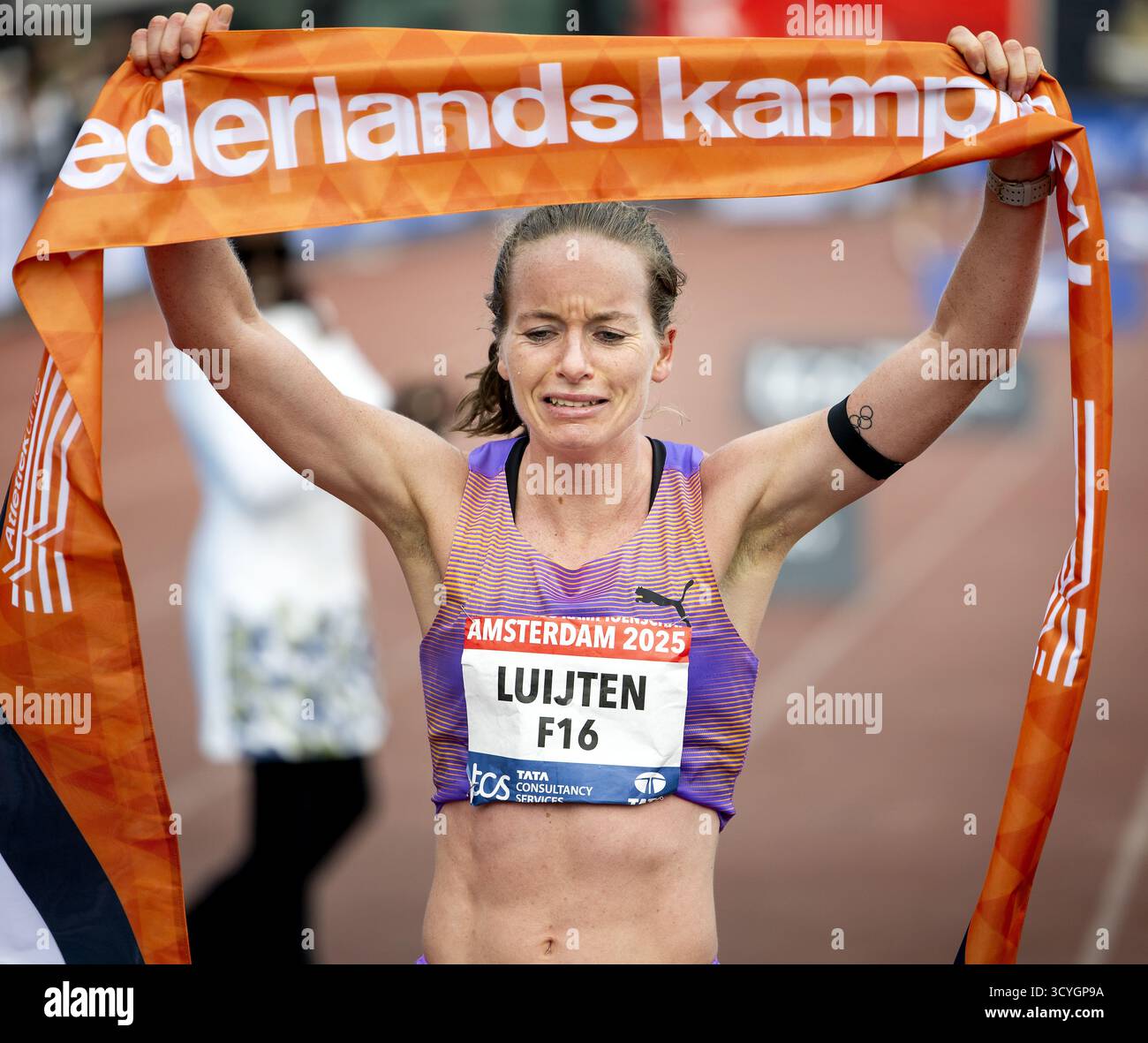 AMSTERDAM – Anne Luijten crosses the finish line of the 50th edition of ...