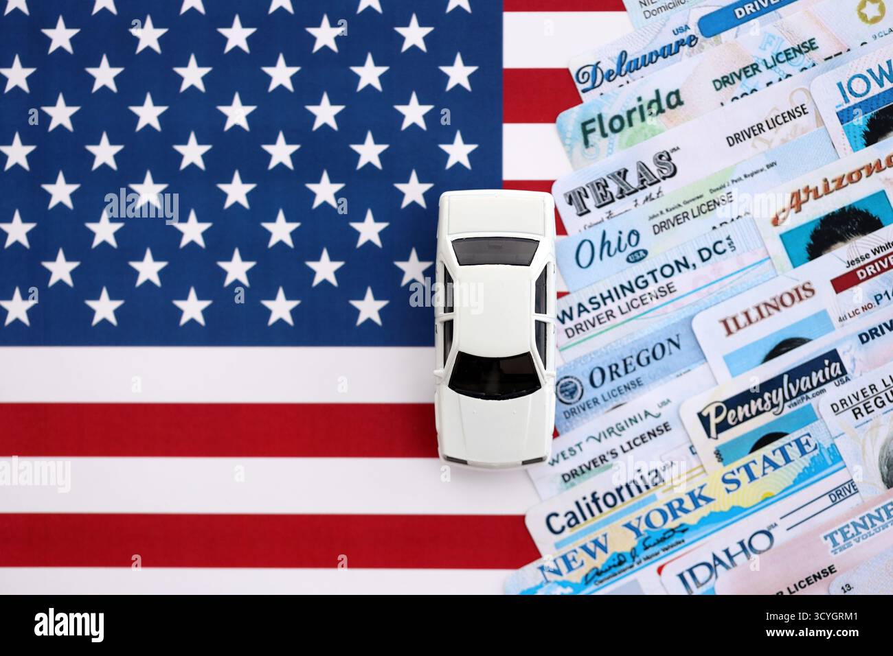 Toy car on big amount of driving licenses from different USA states on ...