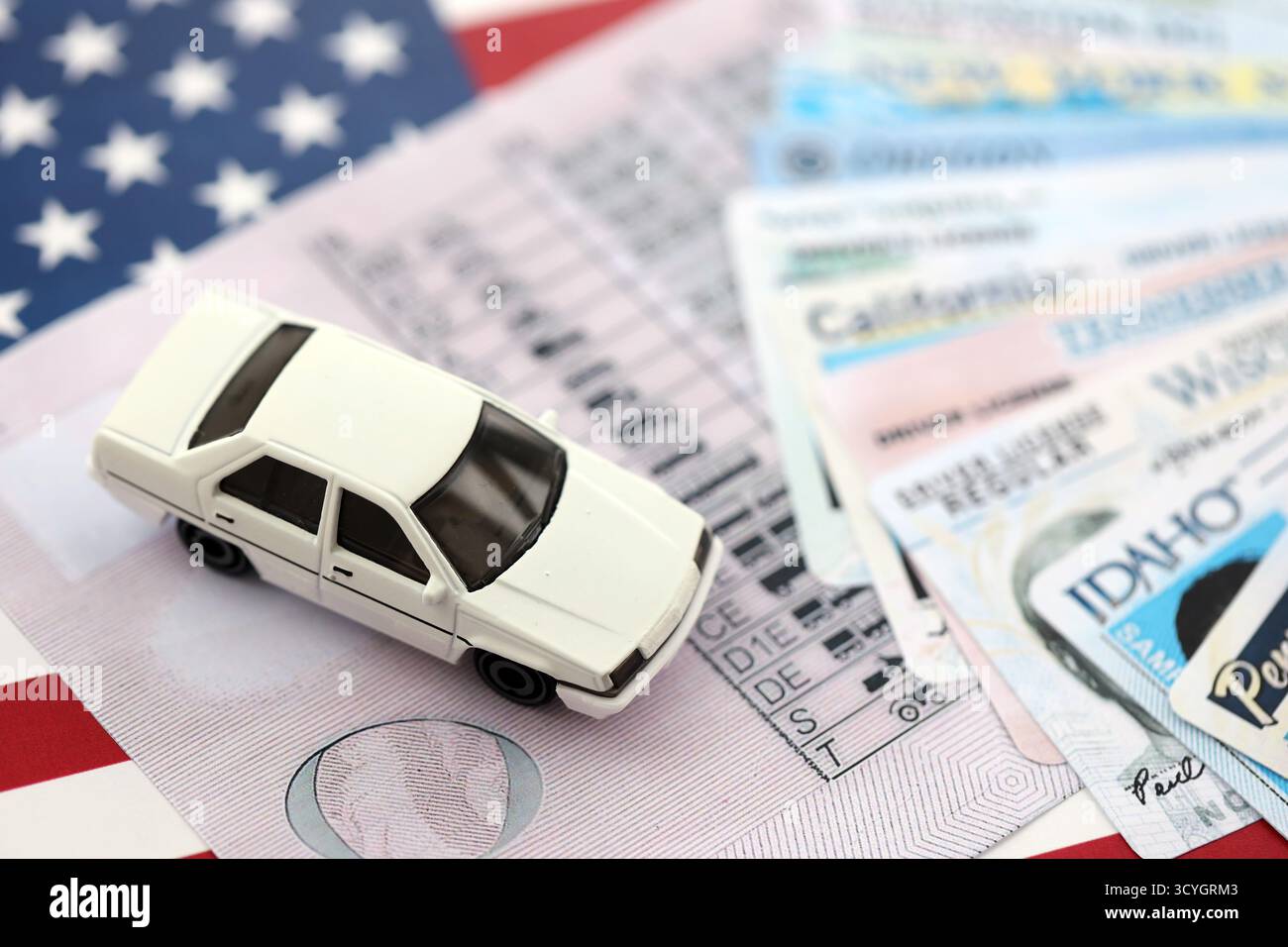 Toy car on big amount of driving licenses from different USA states on ...