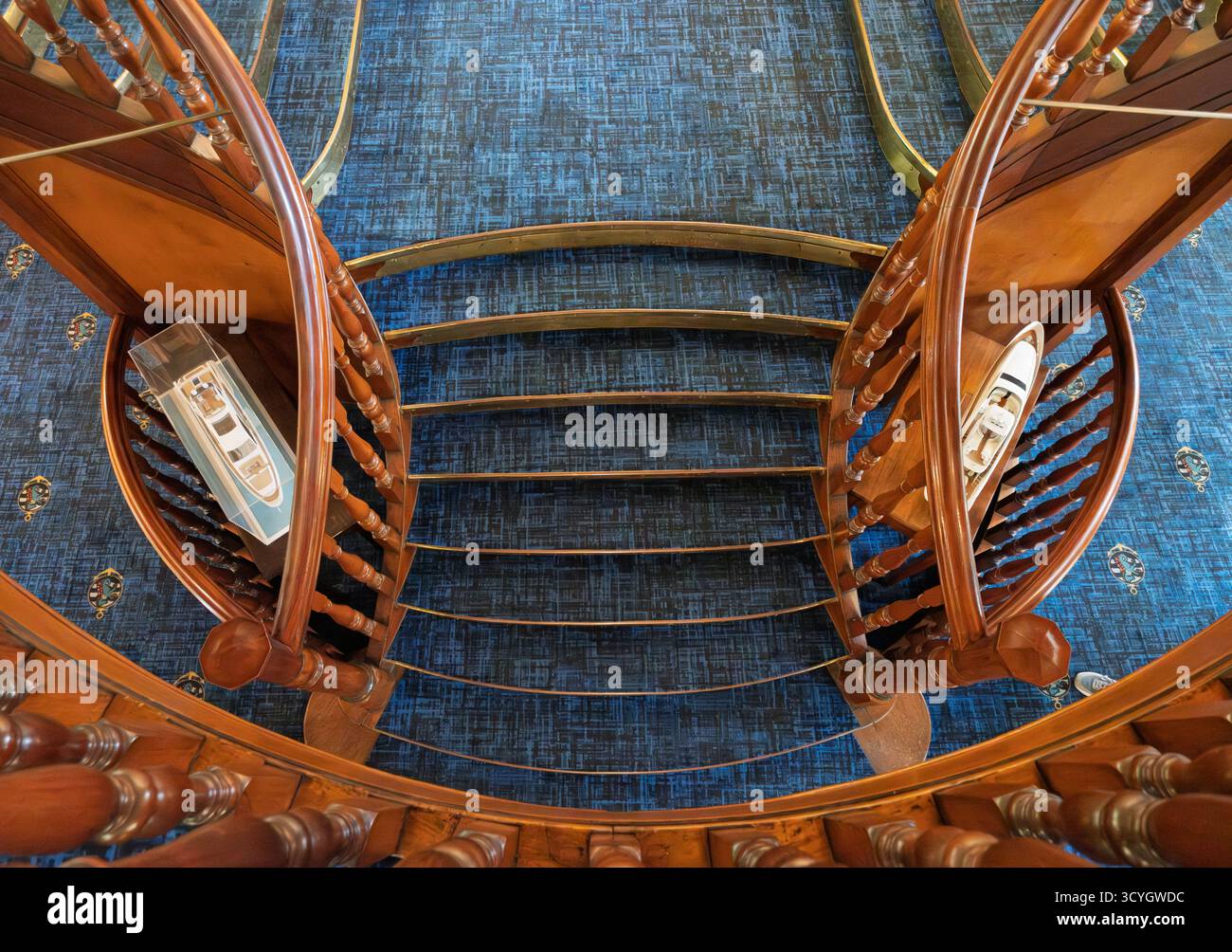 Curved wooden staircase with ship models in display cases aboard HMS ...