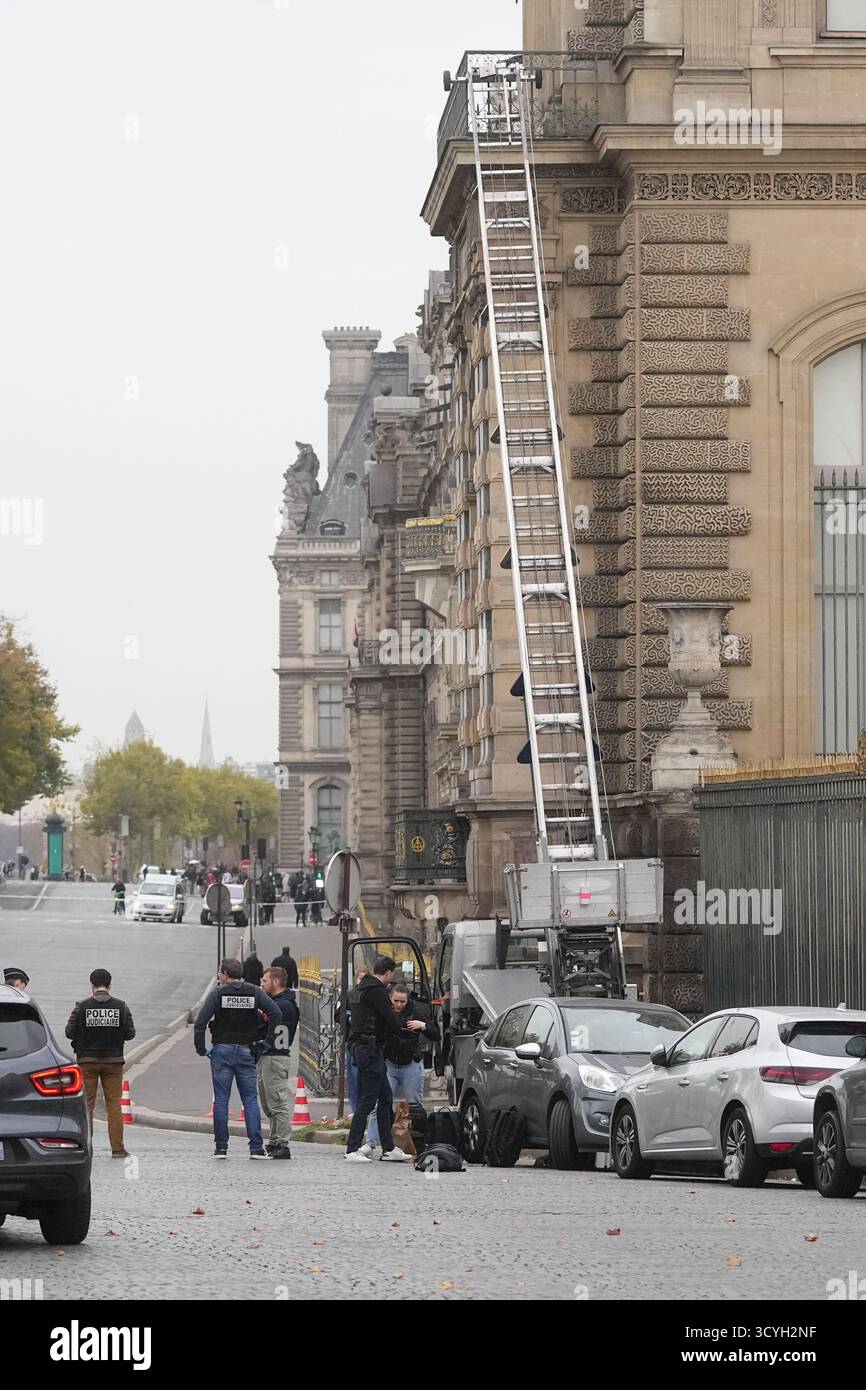 Police officers work by a basket lift used by thieves Sunday, Oct. 19 ...