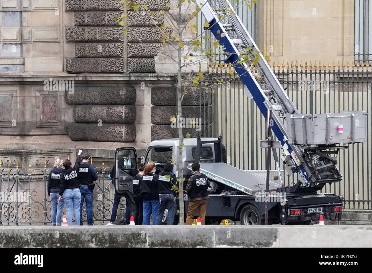 Police officers work by a basket lift used by thieves Sunday, Oct. 19 ...