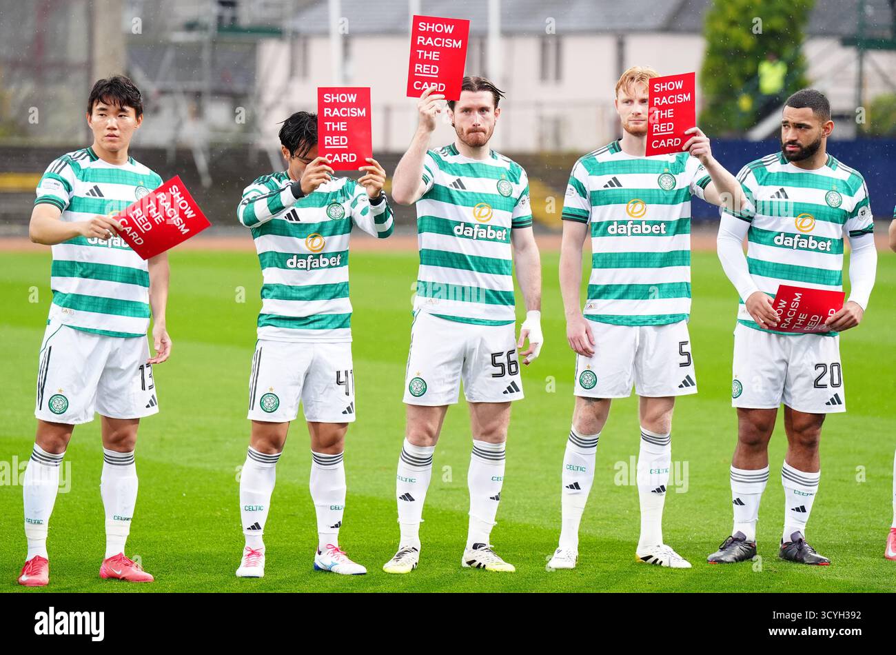 Celtic players hold up Give Racism The Red Card banners ahead of the ...