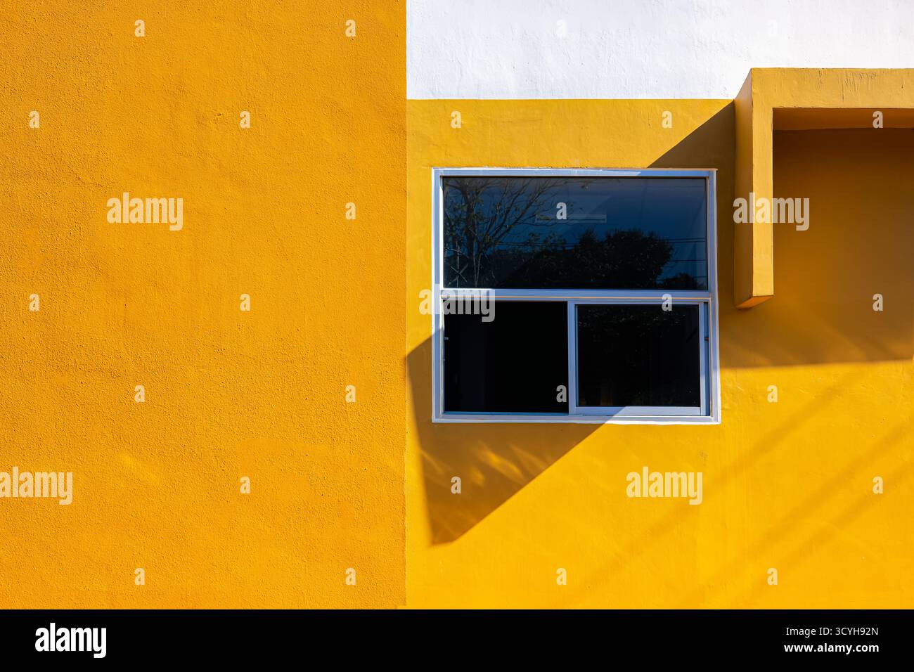 Minimalist architecture with yellow and white wall, modern window, and ...