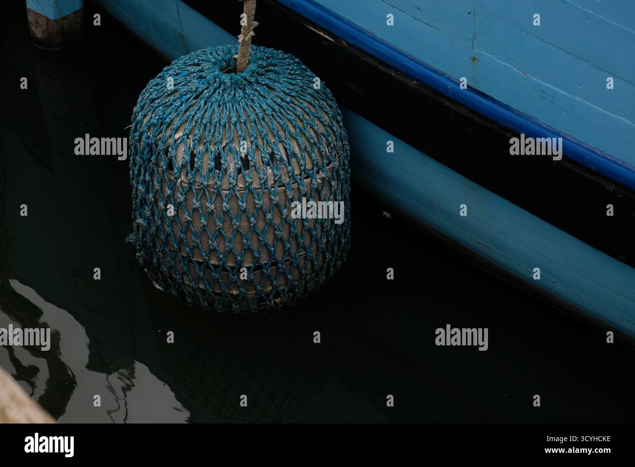 Buoy and mesh mooring close-up, blue boat's hull, France Stock Photo ...