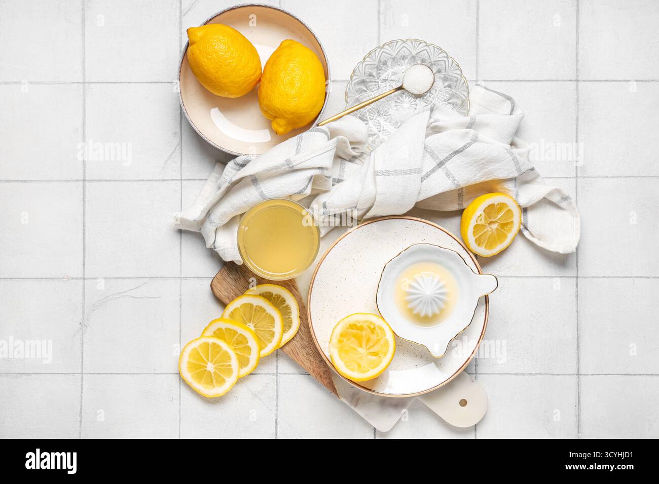 Composition with plate, ceramic juicer and glass of lemon juice on ...