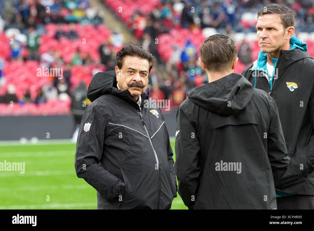 Jacksonville Jaguars owner Shad Khan, left, stands on the field before ...