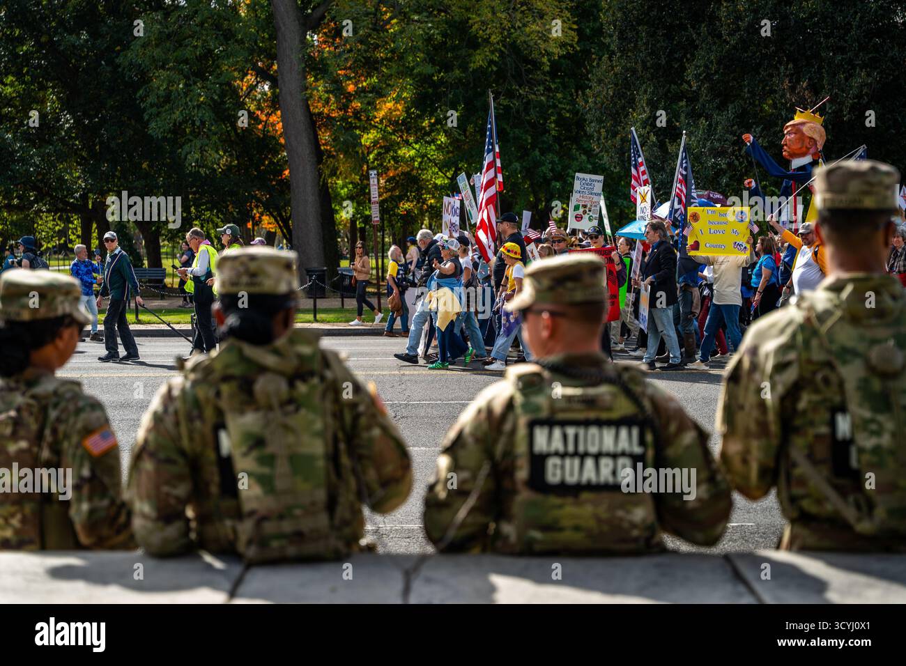 Washington, USA. 18th Oct, 2025. National guardsmen watch as ‘No Kings ...