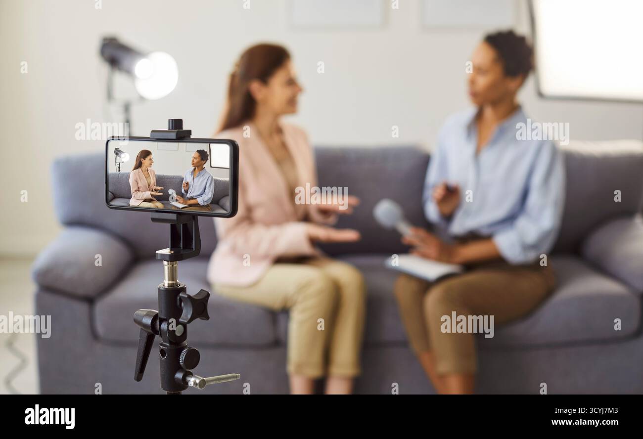 Women recording on smartphone sofa hi-res stock photography and images ...