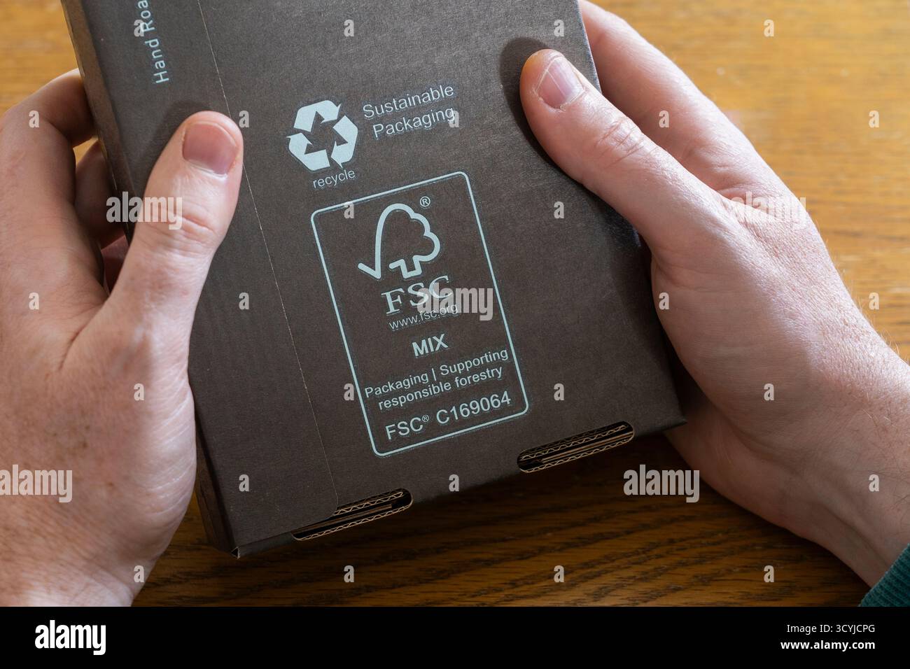 Cardboard packaging with a printed recycling symbol and the FSC logo ...