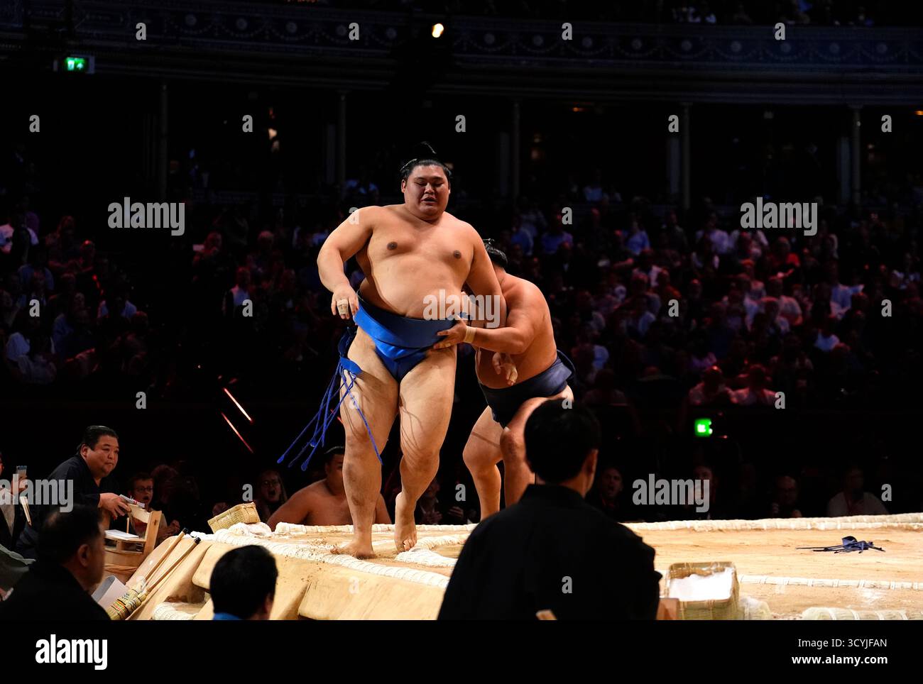 Yokozuna Onosato is thrown out of the ring by yokozuna Hoshoryu on day five of the Grand Sumo ...