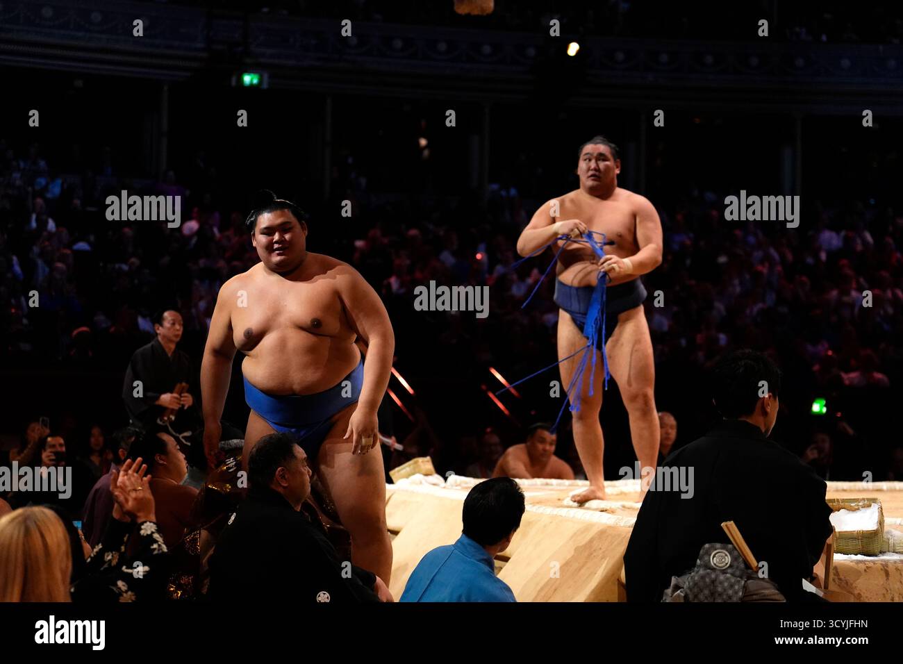 Yokozuna Onosato is thrown out of the ring by yokozuna Hoshoryu on day ...