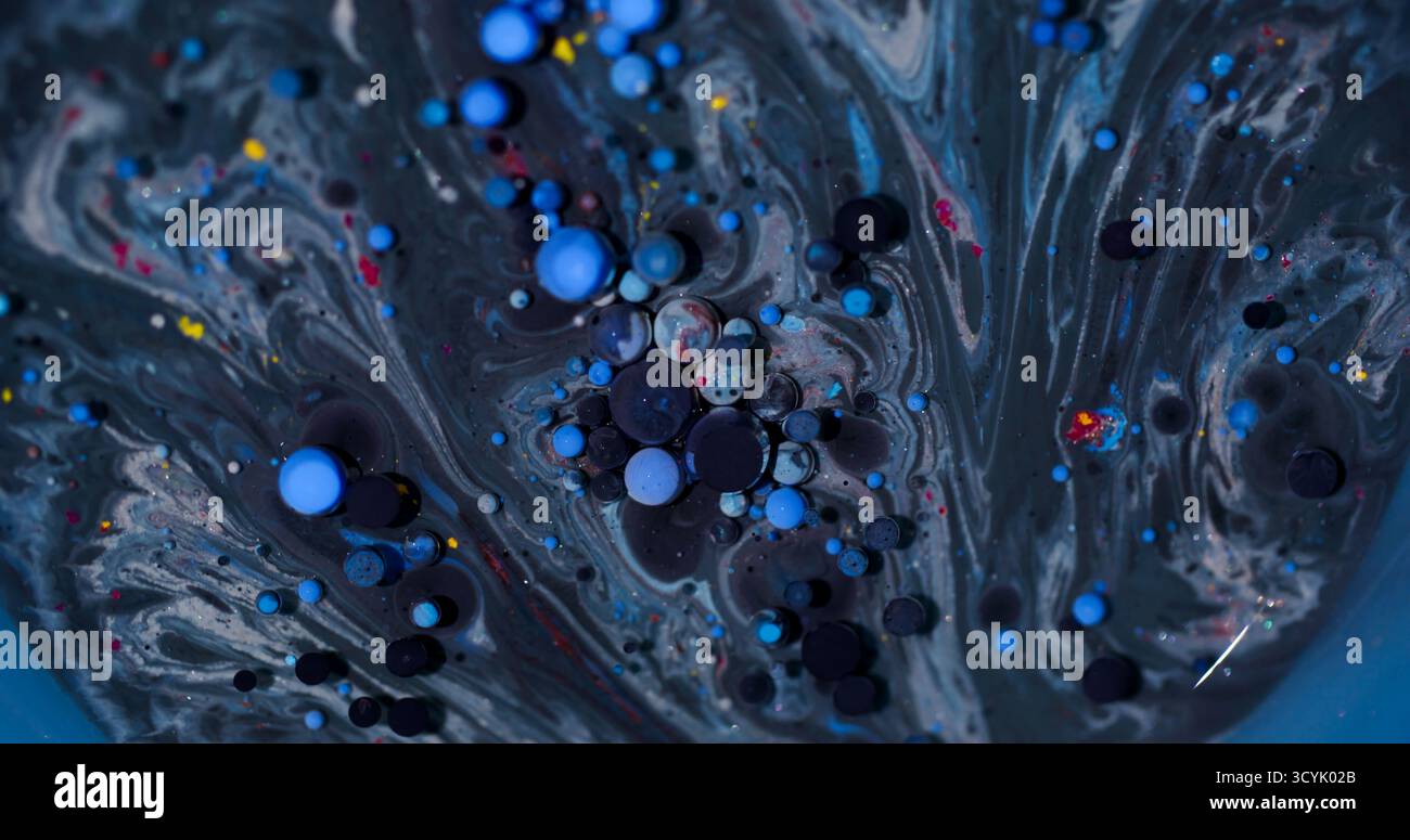 Paint oil. Bubbles mix. Defocused blue yellow purple color liquid ...