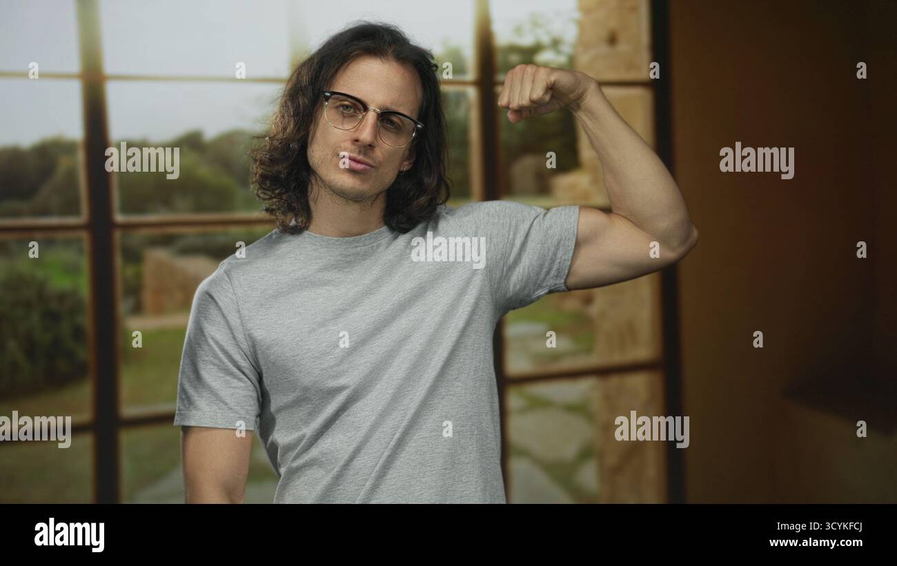 Man flexes arm clenches hi-res stock photography and images - Alamy