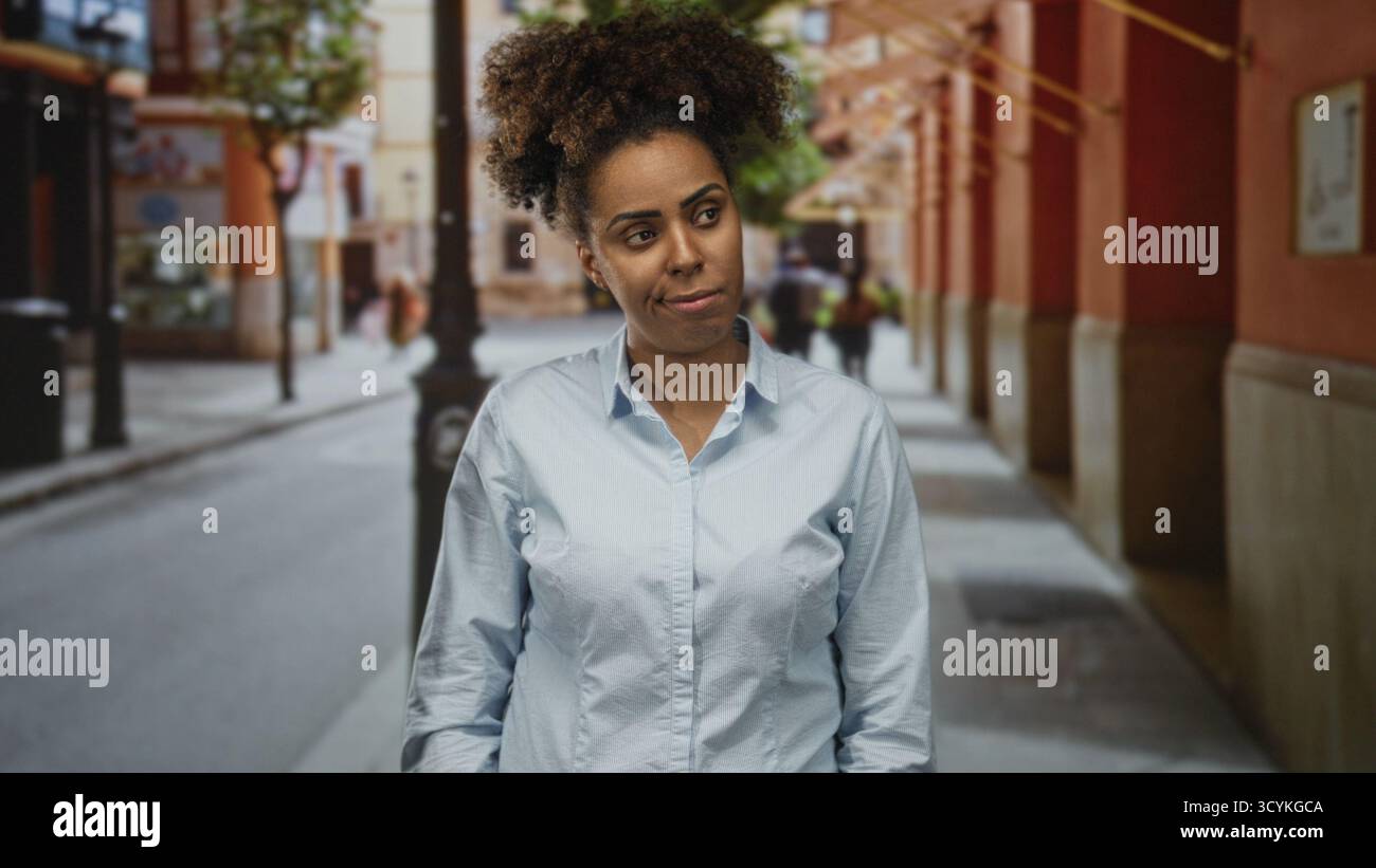 African american woman shrugs hi-res stock photography and images - Alamy
