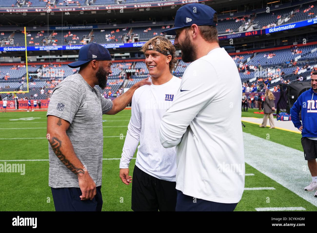 New York Giants quarterback Jaxson Dart, middle, talks with others ...