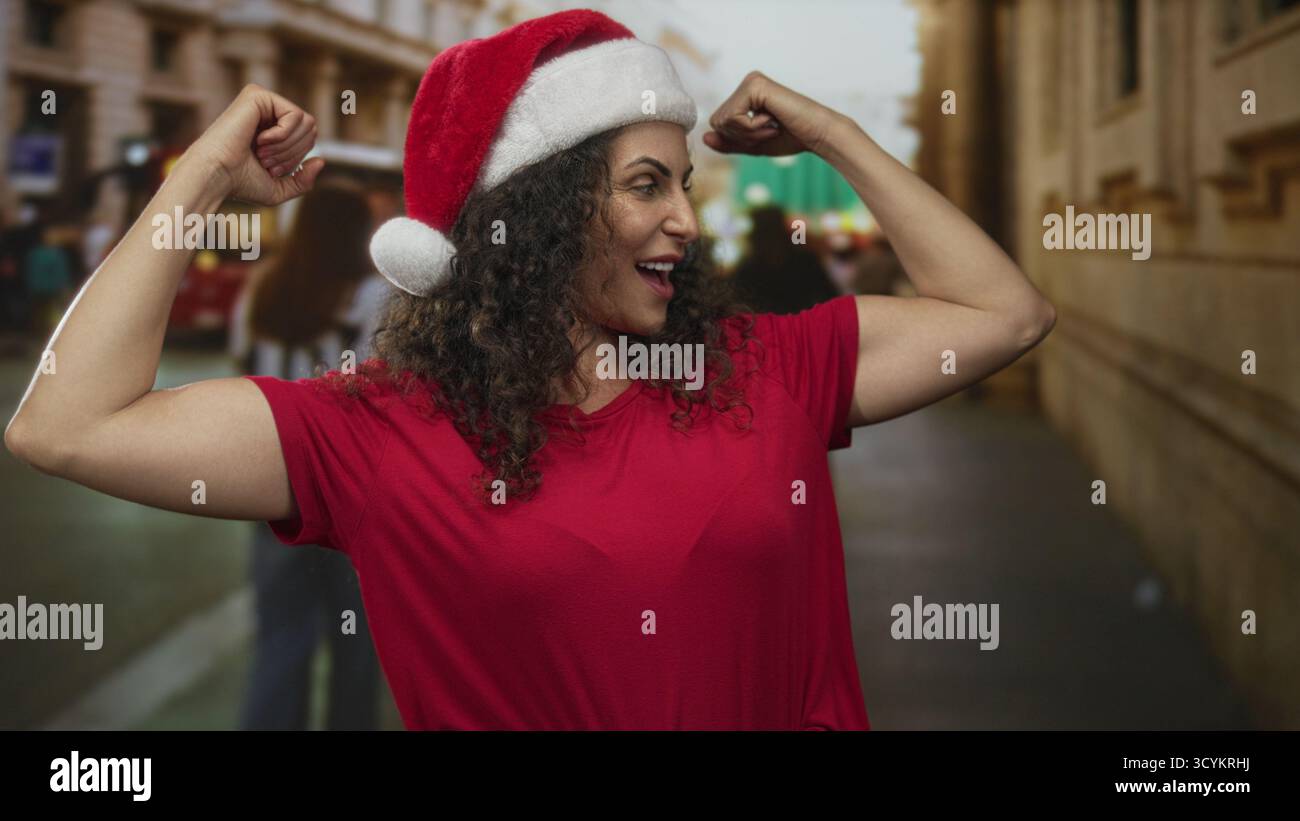 Woman flexes biceps with santa hat on a bustling city street ...