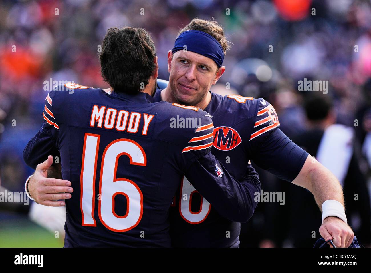 Chicago Bears kicker Jake Moody (16) and long snapper Scott Daly greet ...