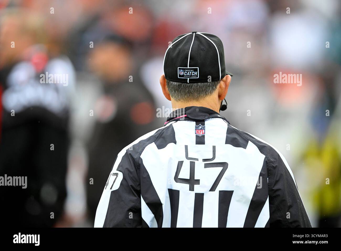 Line judge Tim Podraza wears a Crucial Catch logo on his cap in the ...