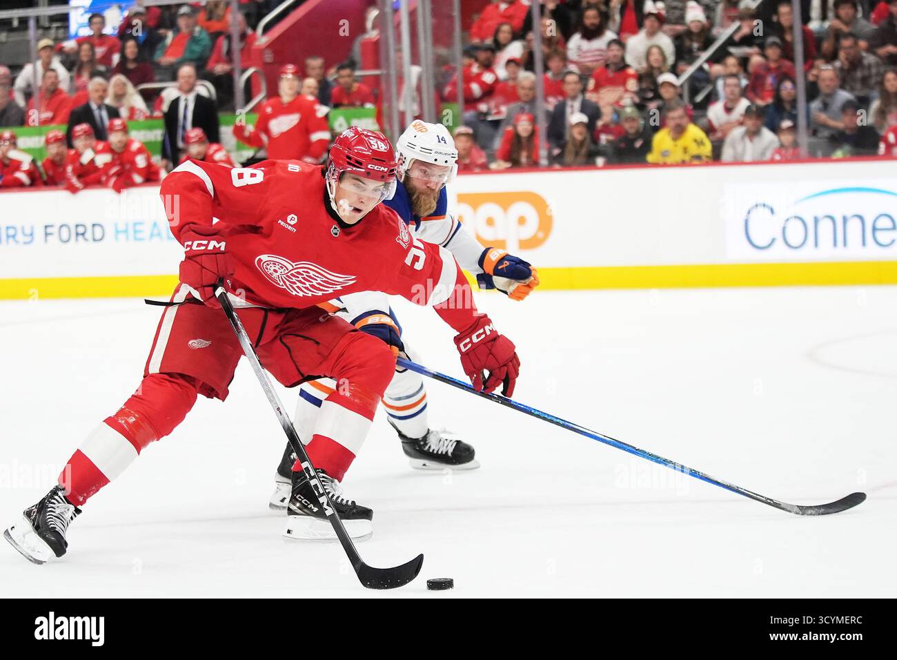 Detroit Red Wings center Emmitt Finnie, left, moves the puck against ...