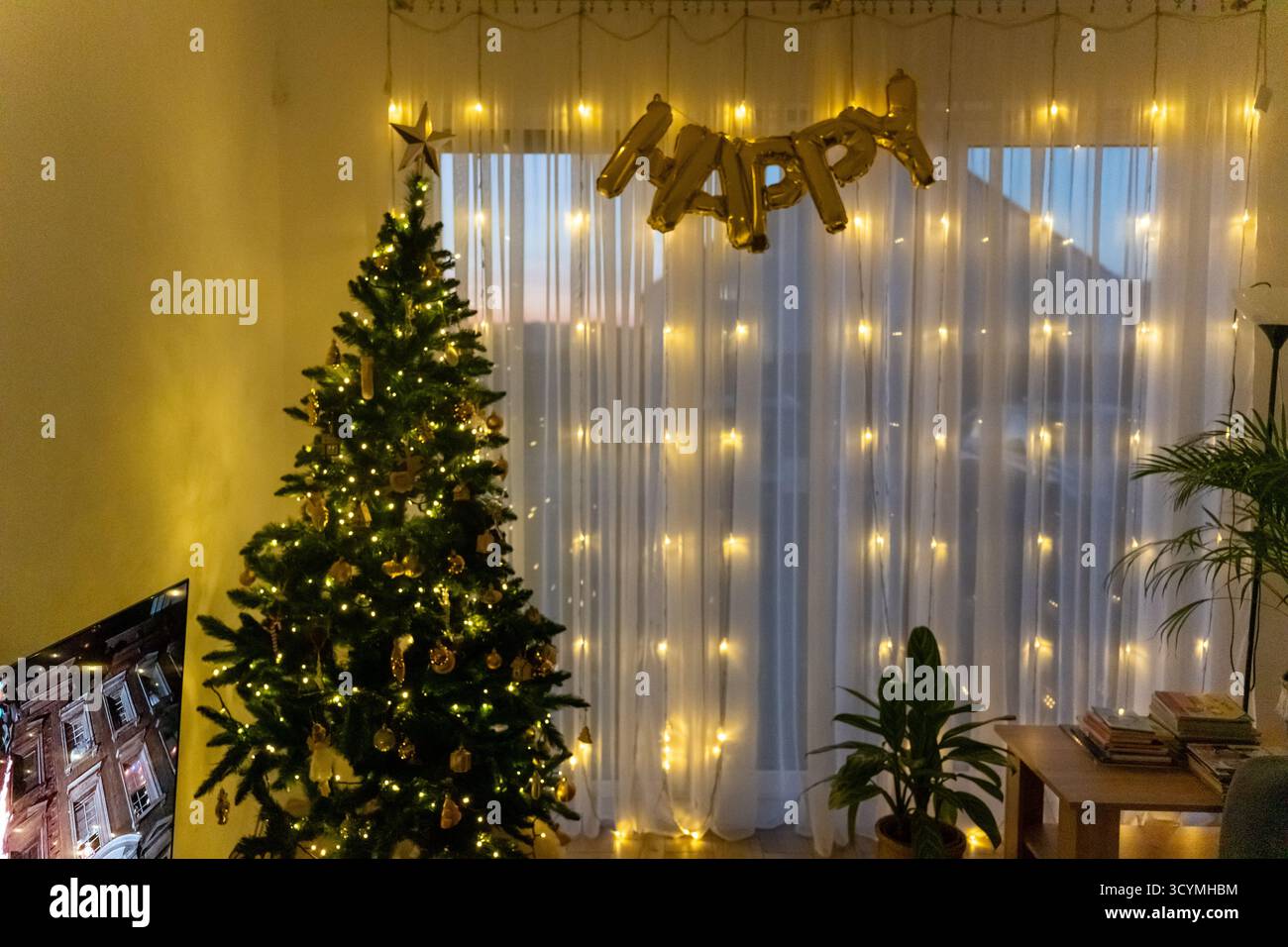 Cozy Christmas living room interior with decorated tree, golden balloon ...