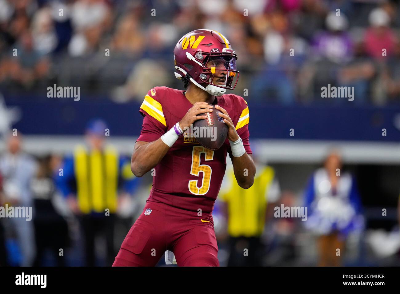 Washington Commanders quarterback Jayden Daniels looks to pass against ...