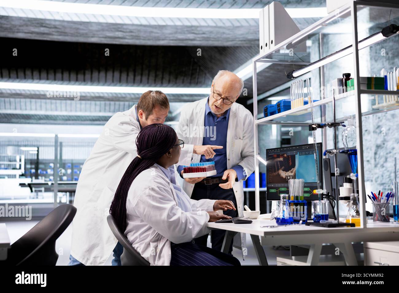 Scientists team handles blood samples in test tube within laboratory ...