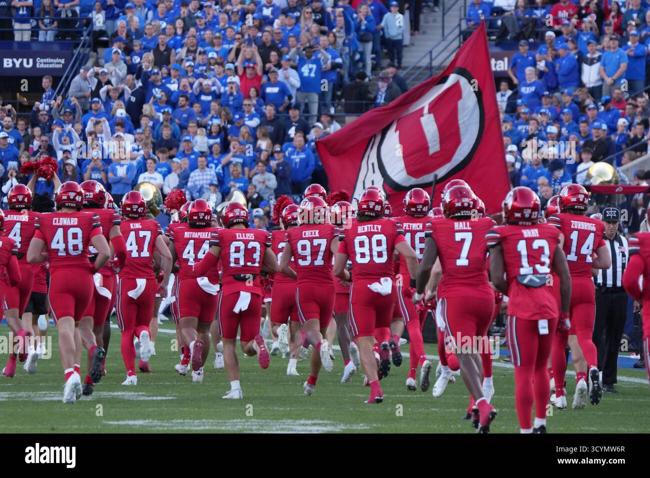 Utah players run unto the filed before an NCAA college football game ...