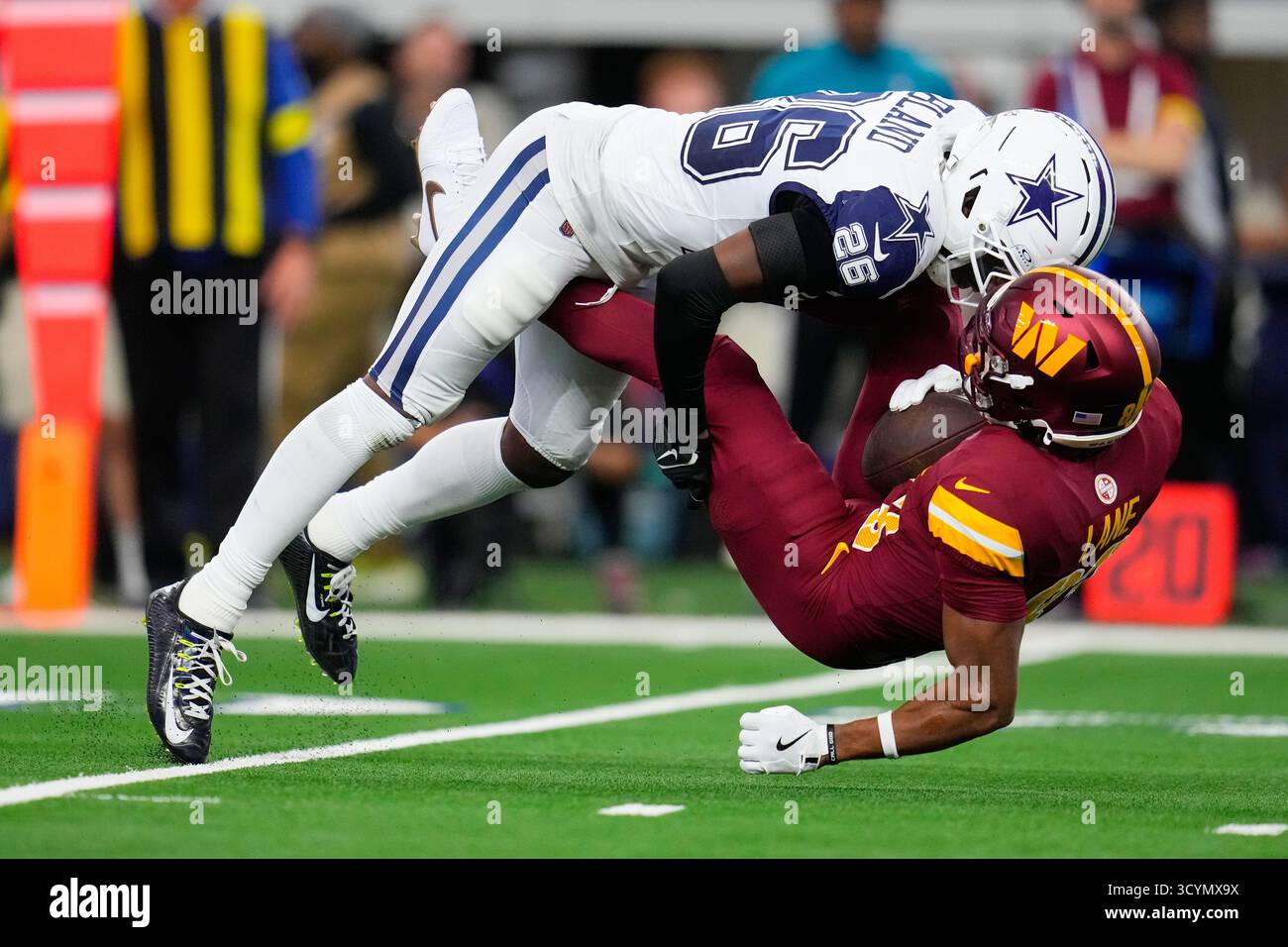 Washington Commanders wide receiver Jaylin Lane, bottom, is tackled by ...