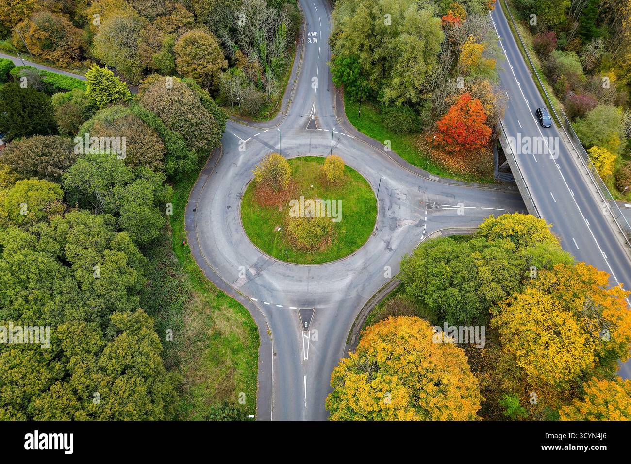 Overhead view of a roundabout in Wales, UK, with bilingual road ...