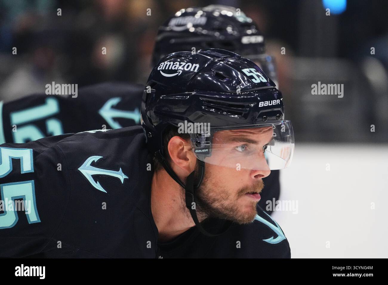 Seattle Kraken defenseman Ryan Lindgren looks on during a face-off ...