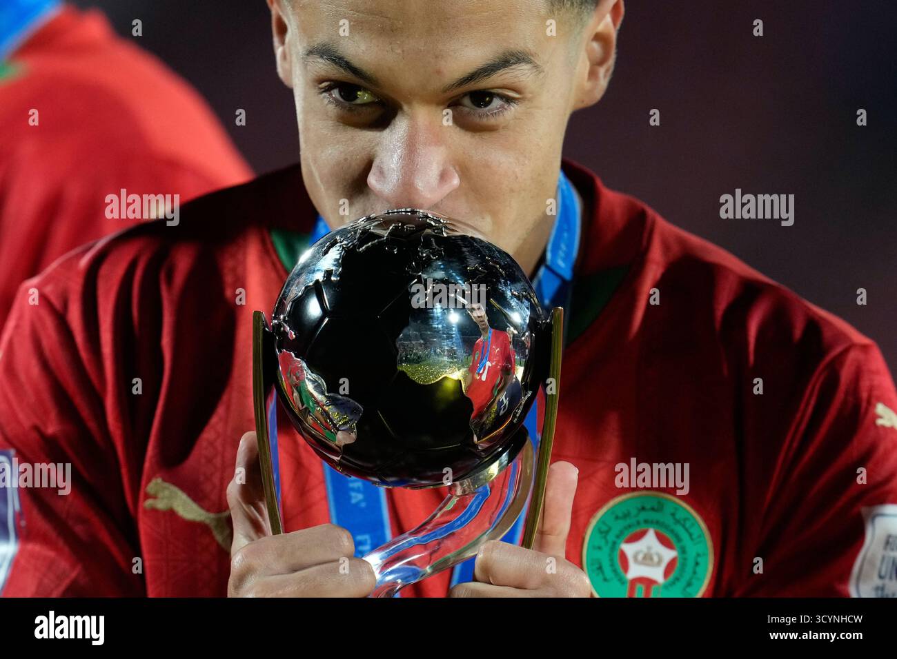 Morocco Yassine Khalifi kisses the trophy after defeating Argentina in ...
